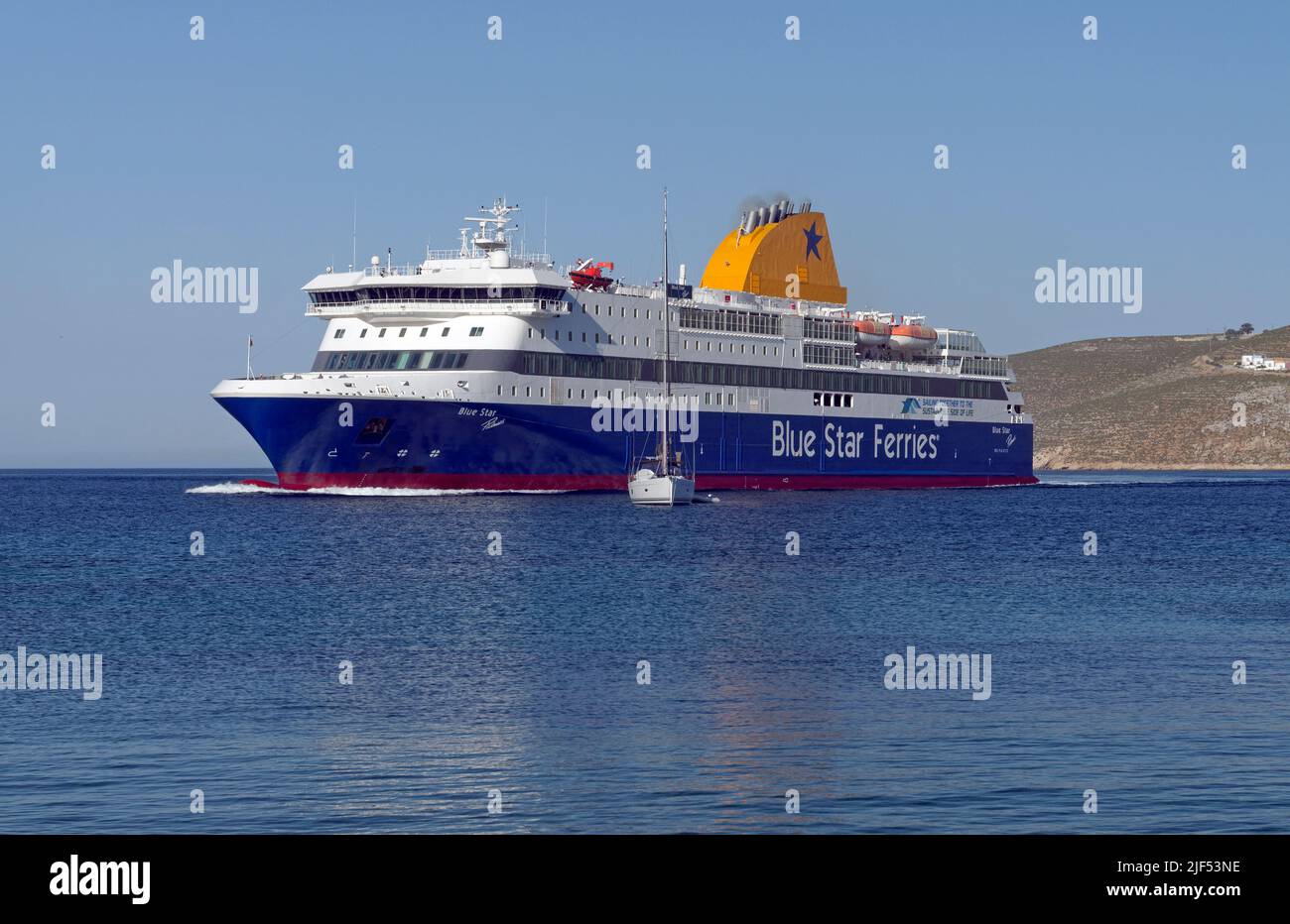 Blue Star, the Patmos ferry, manoeuvres around small sailing boat as ...