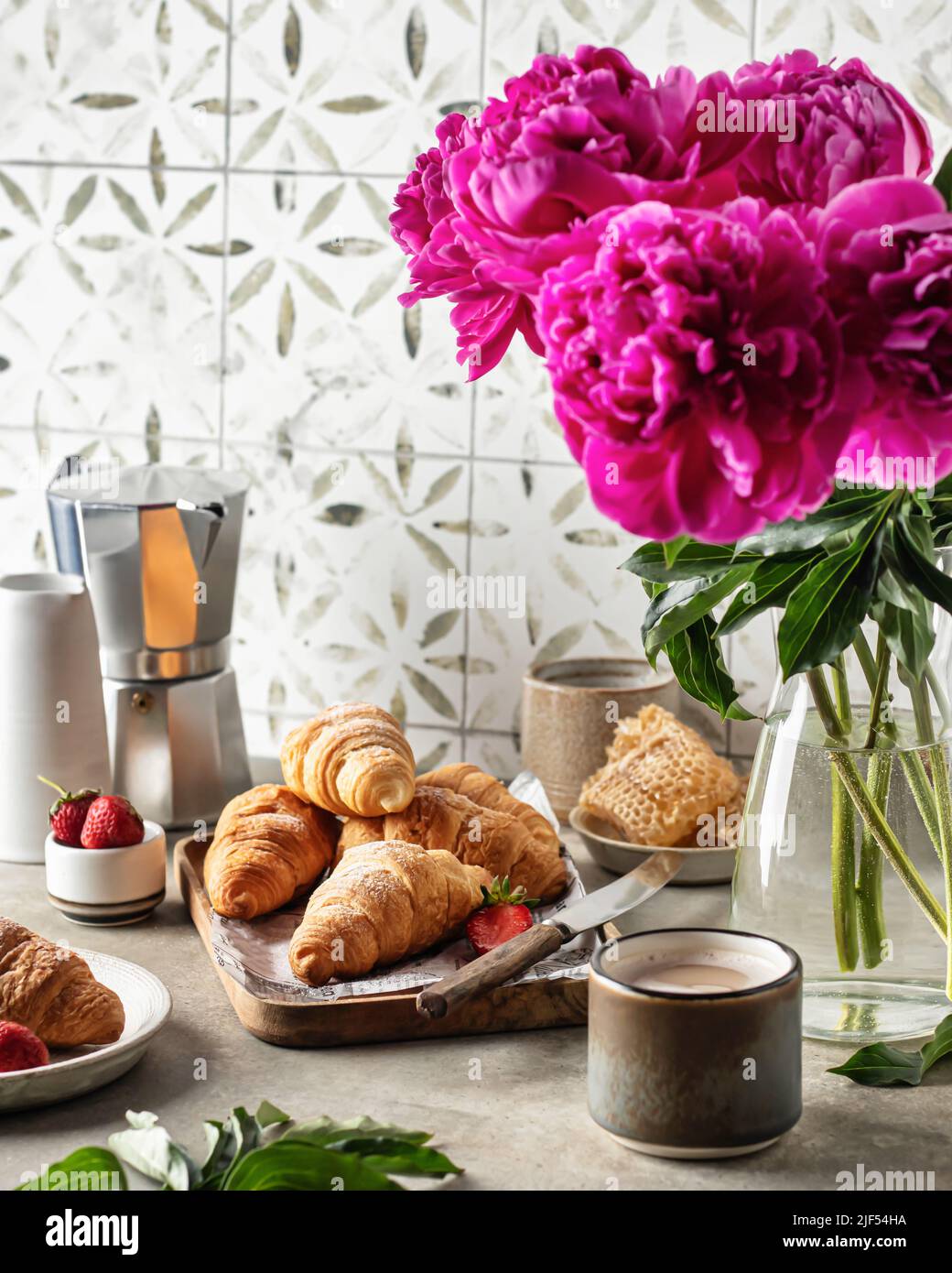 Delicious breakfast with croissants, coffee, peonies flower, honey ...
