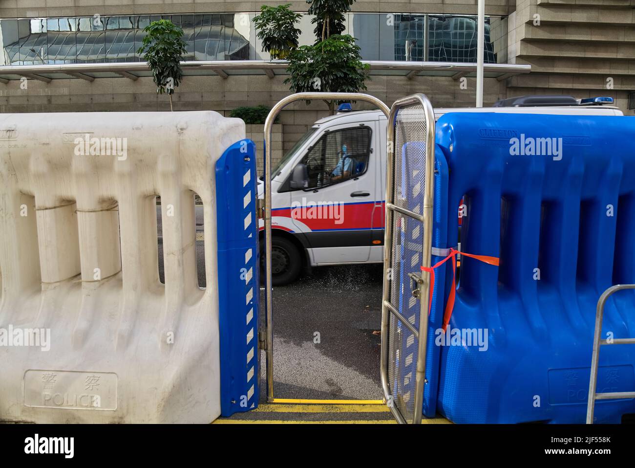 A police van drives past the barrier guarding the exhibition center in ...