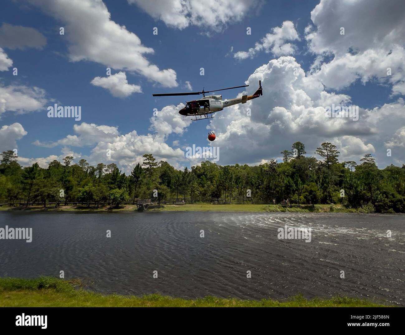 A 413th Flight Test Squadron UH-1 Huey leaves Anderson Pond to perform ...
