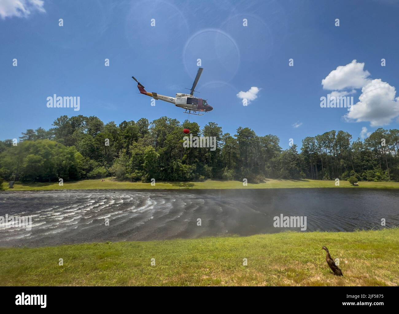 A 413th Flight Test Squadron UH-1 Huey leaves Anderson Pond to perform ...