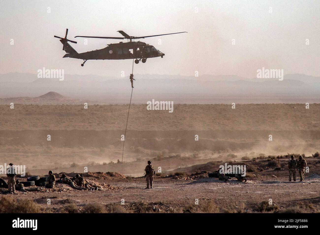 A Tunisian Armed Forces soldier conducts a fast rope descent from a UH ...