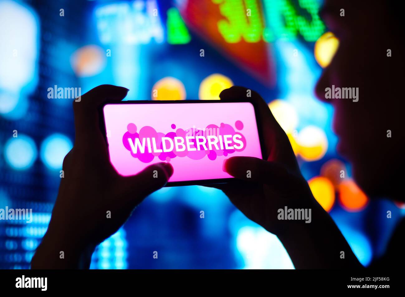 In this photo illustration, a silhouetted woman holds a smartphone with ...