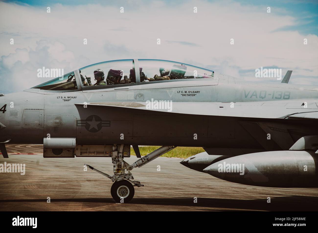 U.S. Navy Lt. S. A. McKay, a Navy EA-18G Growler pilot, gives a hand ...