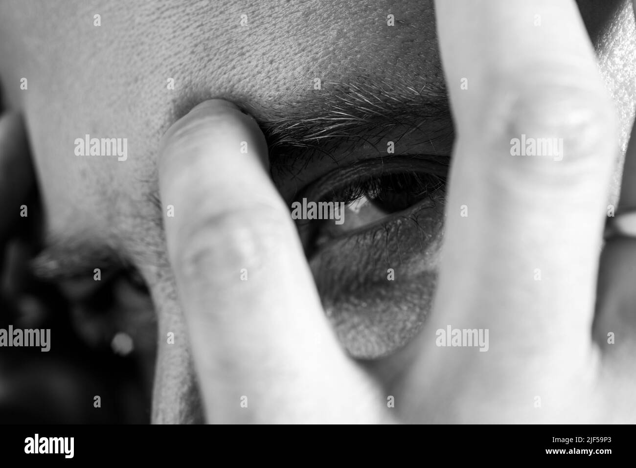 Close up portrait of handsome man. Guy covered face with hands and ...