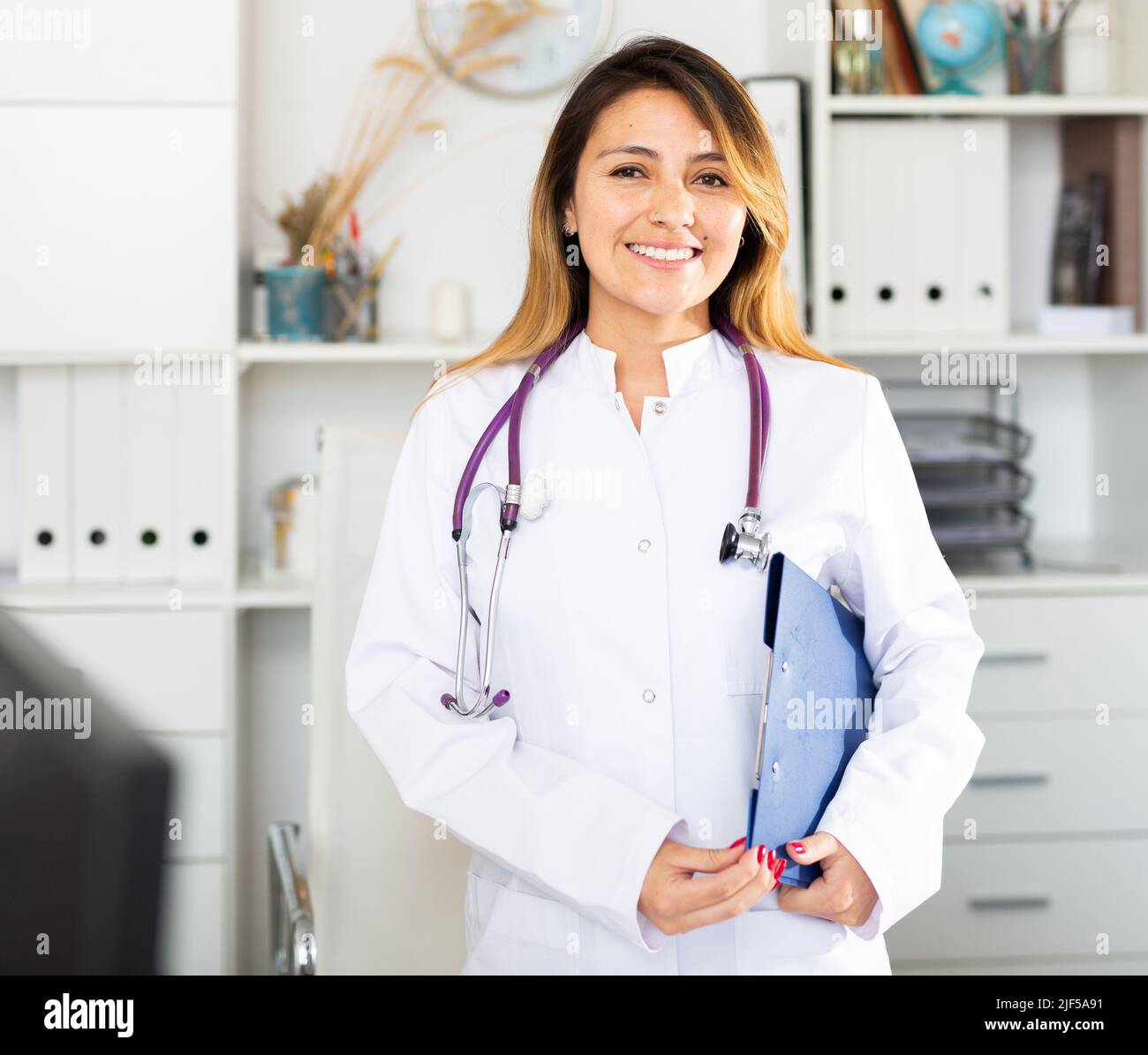 Young mexican female medic in uniform holding clipboard Stock Photo - Alamy