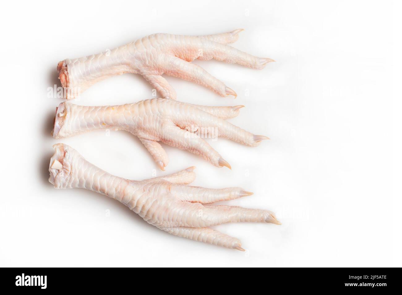 Chicken feet on white background, space for text Stock Photo - Alamy