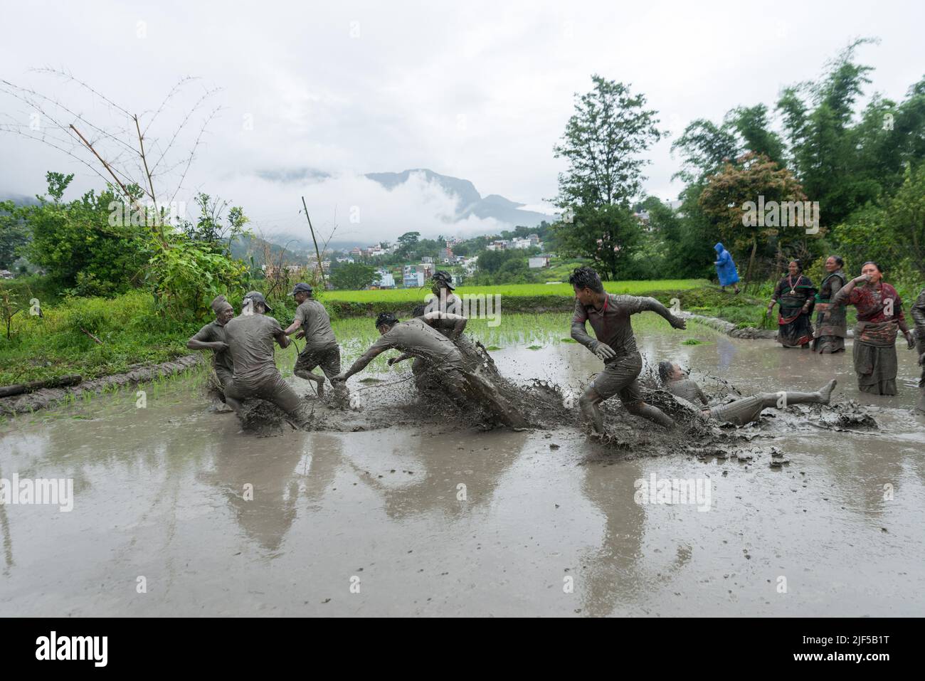 Kathmandu, Nepal. 29th June, 2022. People play in mud water in a paddy ...