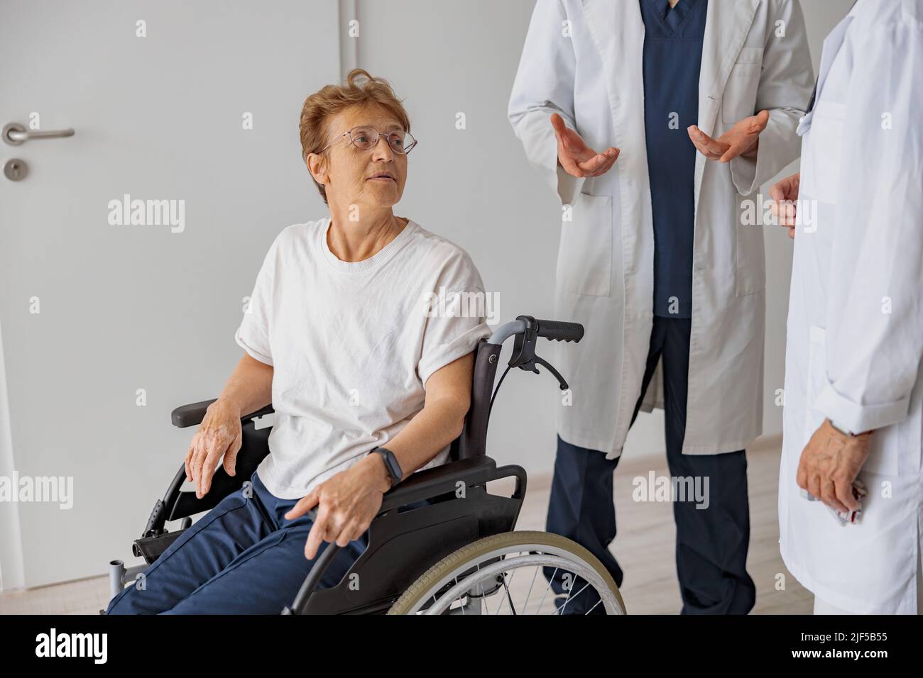 Professional doctors discuss over patient's diagnosis standing in ...