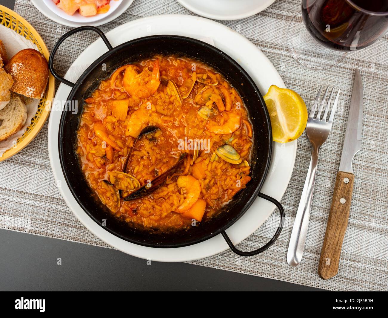 Traditional dish of Spanish cuisine is paella with seafood Stock Photo ...