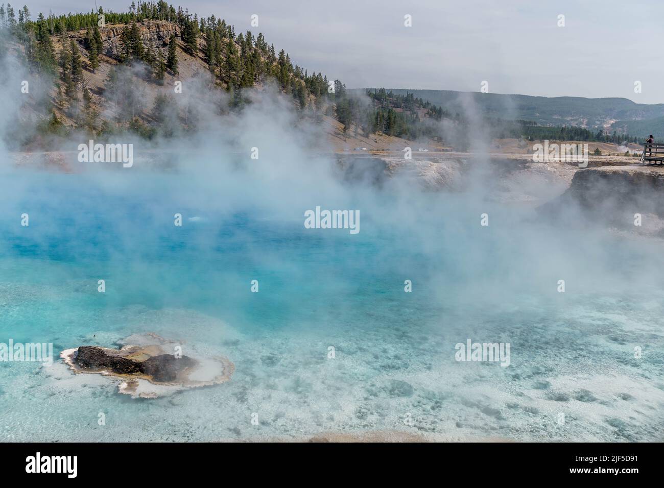 The rising steam from blue hot springs in Yellowstone National Park ...