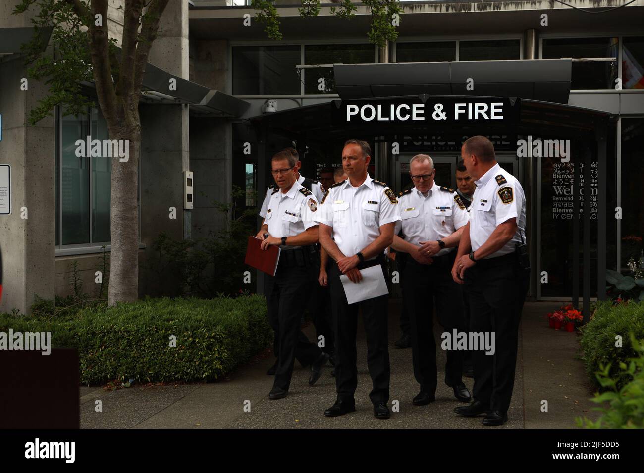 Saanich Police Chief Constable Dean Duthie, centre, waits with fellow ...