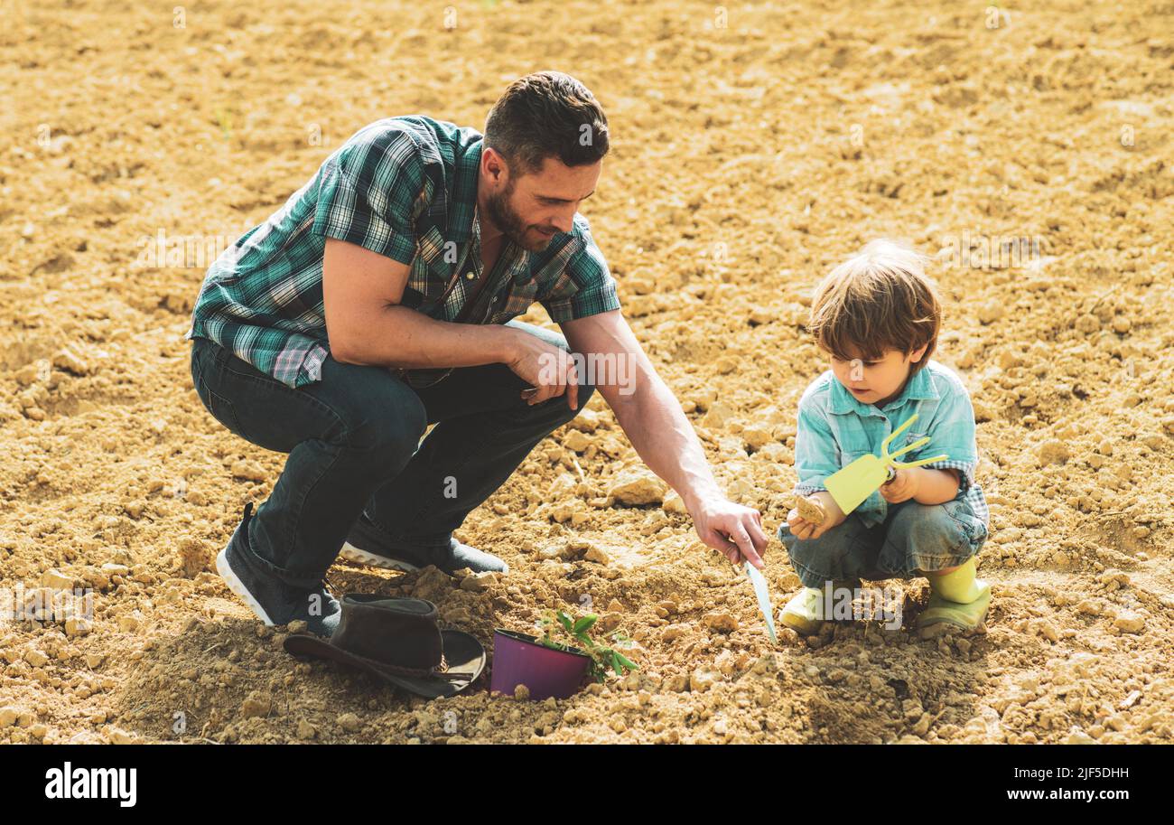 Father and son planting. Growing plants. Spring garden. Dad teaching ...