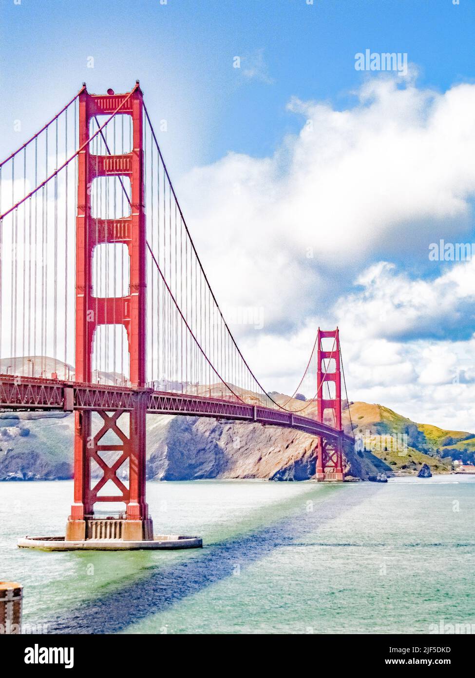 A vertical shot of the Golden Gate Bridge under a sunny blue sky Stock ...