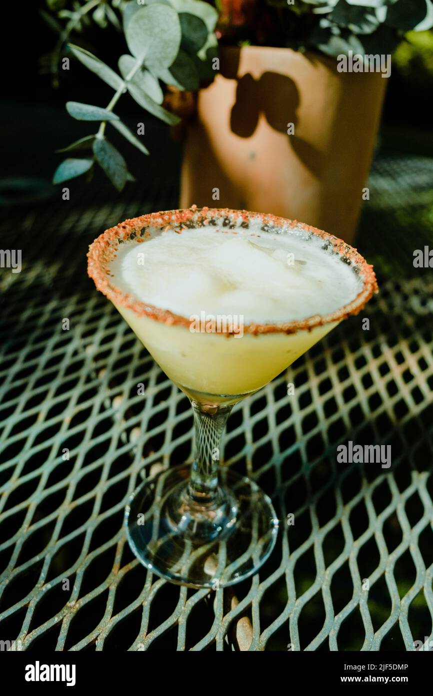 A vertical closeup shot of a cold delicious martini on a table Stock ...