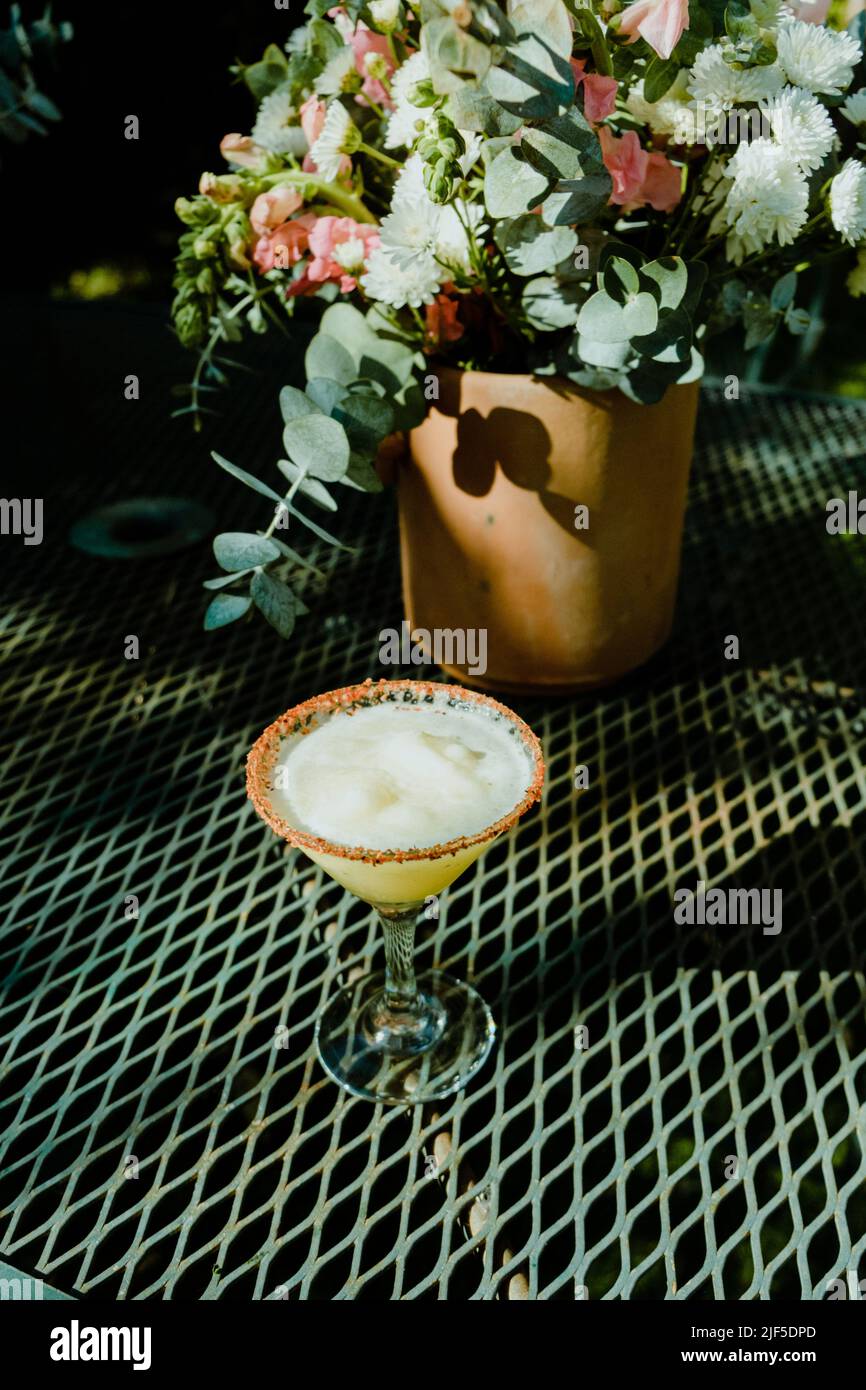 A vertical high angle shot of a fancy martini near a potted plant Stock ...