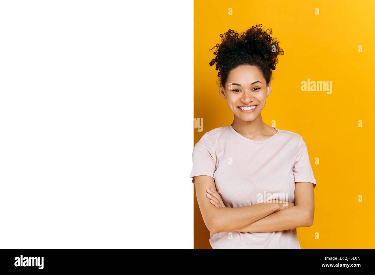 Positive lovely confident african american young woman, stands on an ...