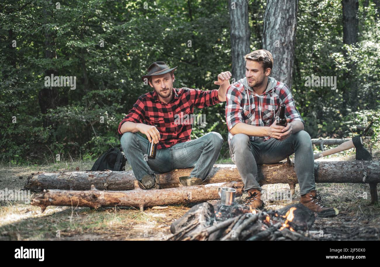 Happy young people camping in woods. Summer lifestyle. Young guy having ...