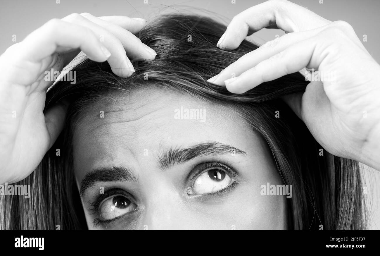 Woman with hair problem. Woman is looking shocked to her lost hair ...