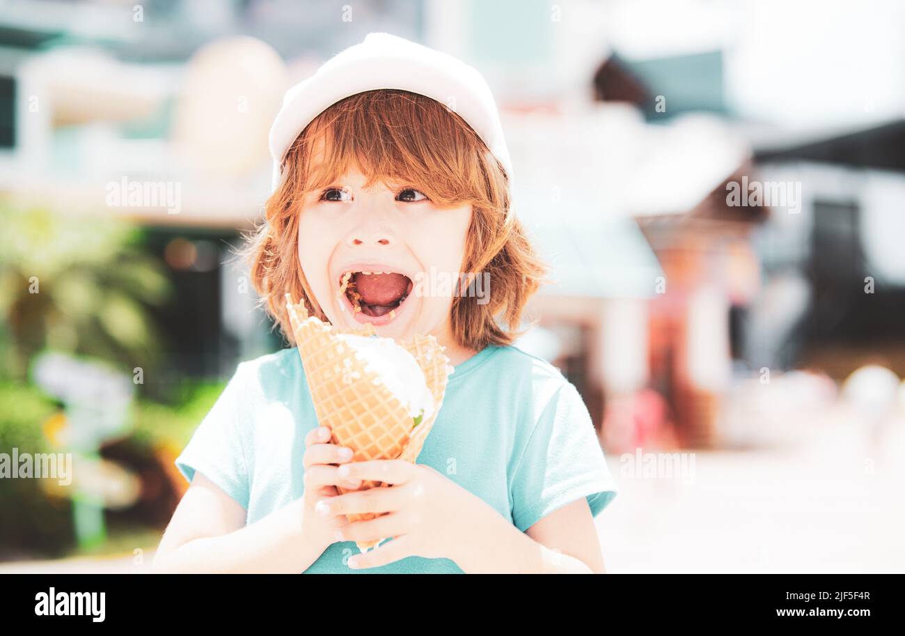 Cute kid eating licking big ice cream in waffles cone happy laughing on ...