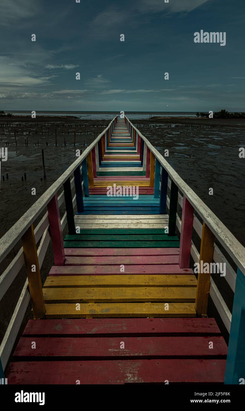 The walkway on Rainbow bridge or Old wood colorful bridge pier extends ...