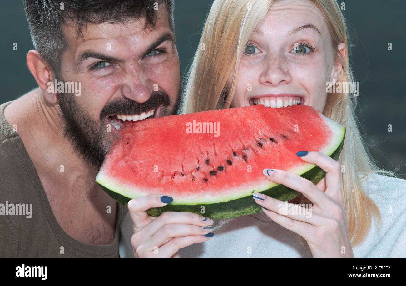 Happy carefree couple eat watermelon. Vitamins and healthy concept ...