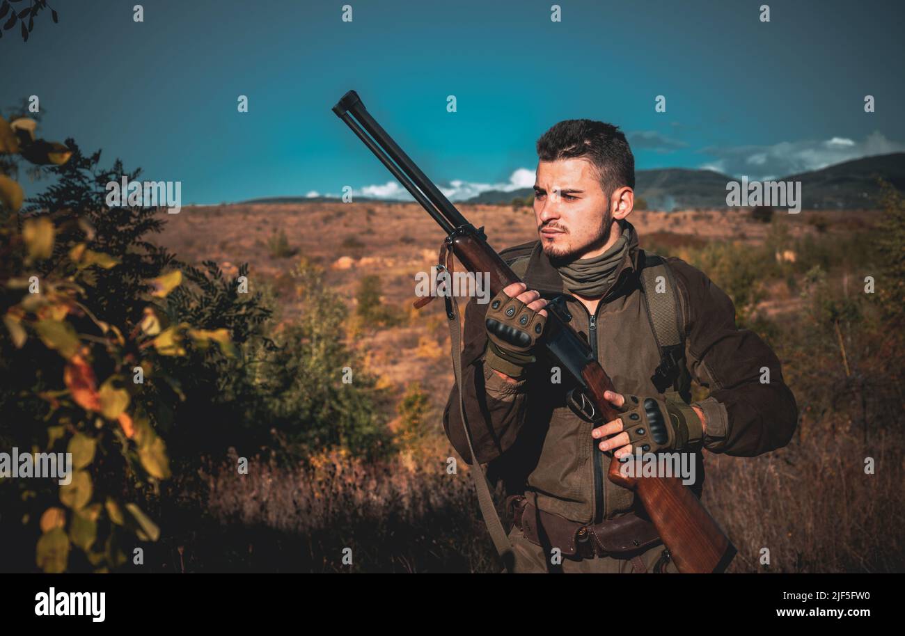 Hunter moving with shotgun looking for prey. Hunter in camouflage ...