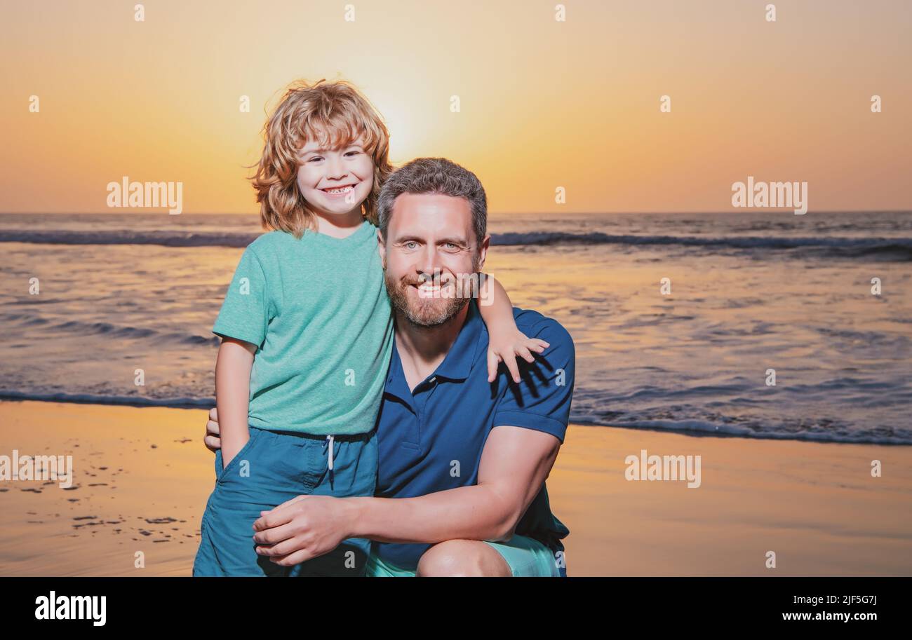 Father and son hugging on beach sunset. Little son embrace daddy on a ...
