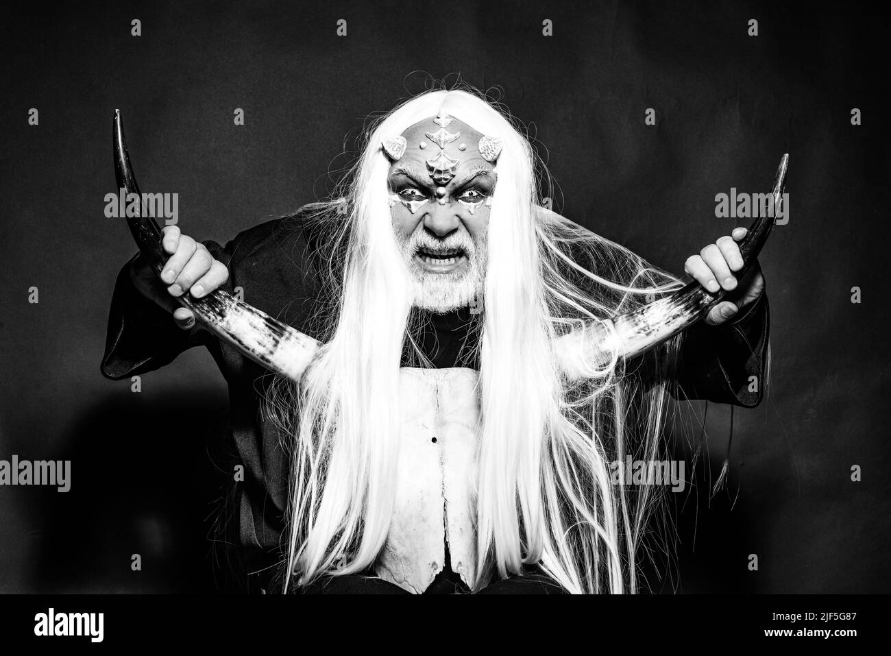 Druid on black background. Alien with dragon skin and grey beard ...