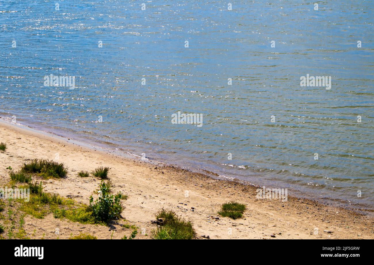 Sandy river bank with grass, coastline with blue water, top view Stock ...
