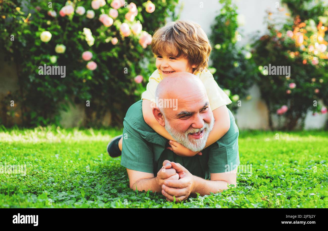 Happy family Grandson hugs his grandpa on holiday. Grandfather and ...
