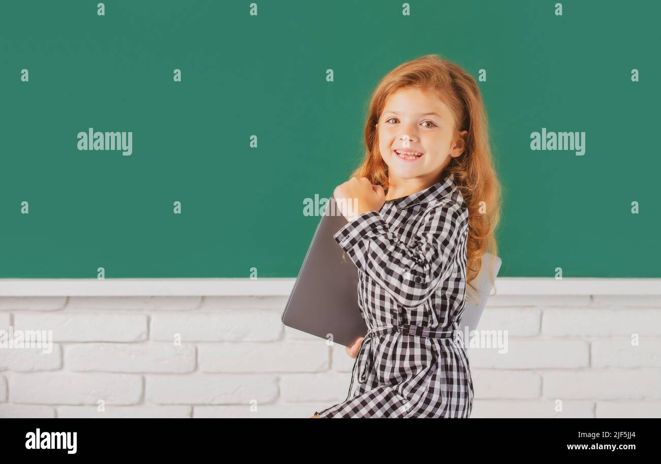 Portrait of cute, lovely, girl in school uniform in classroom. Genius ...