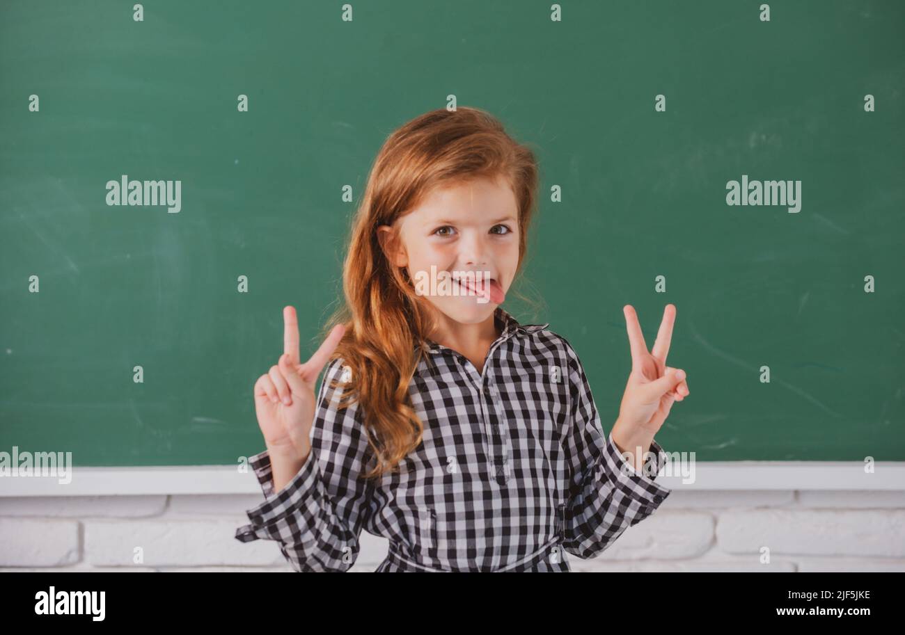Portrait of funny pupil girl of primary school study. Funny kid girl at ...