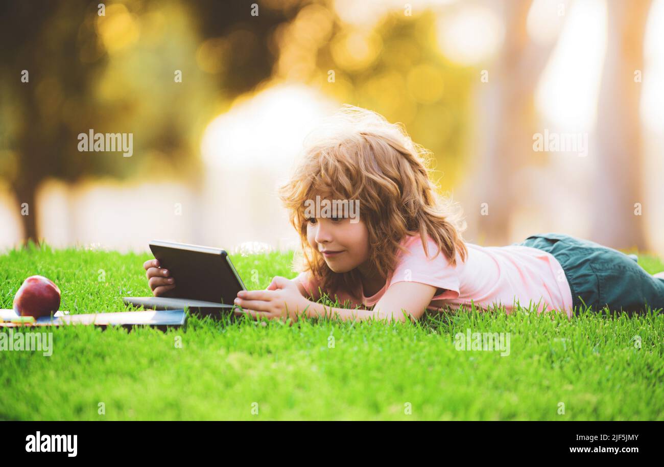 Cute child boy studies and learn outside Stock Photo - Alamy