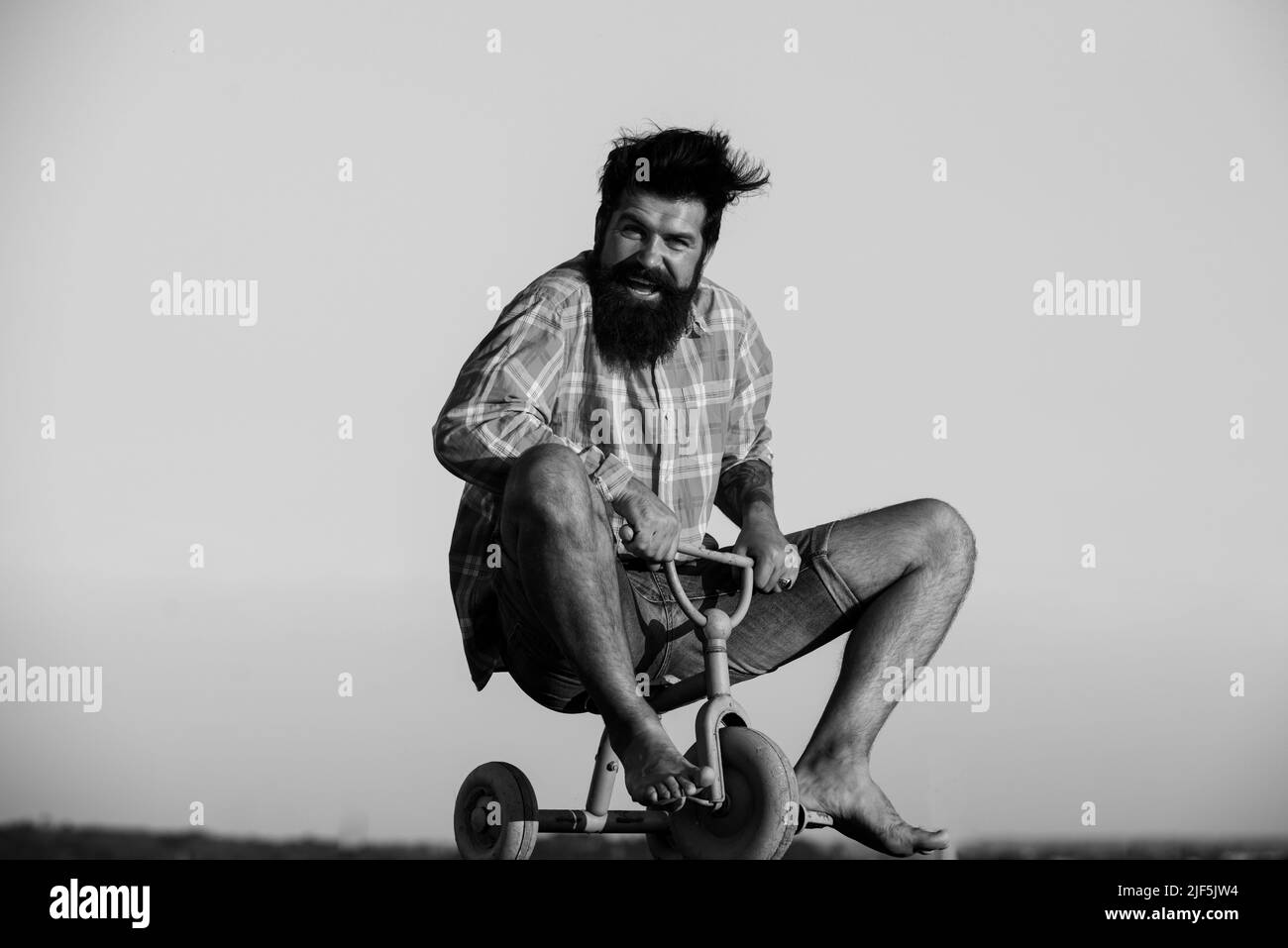 Crazy man bicyclist riding three wheeled bicycle Stock Photo - Alamy