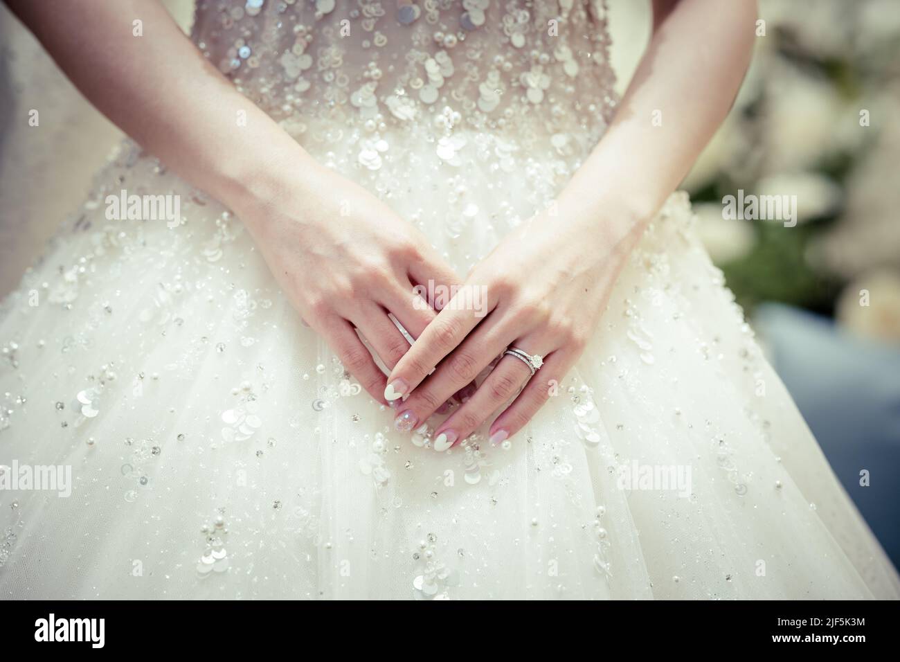 Bride hand with a wedding ring on the background of dress, Detail image ...