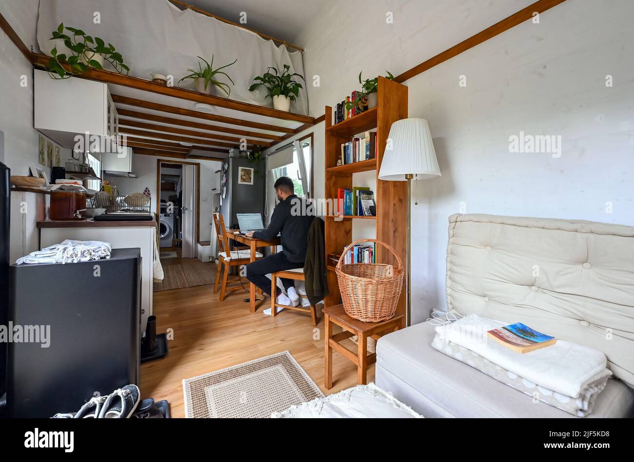 Waldbronn, Germany. 27th June, 2022. Jacek Hage sits in his Tiny House ...