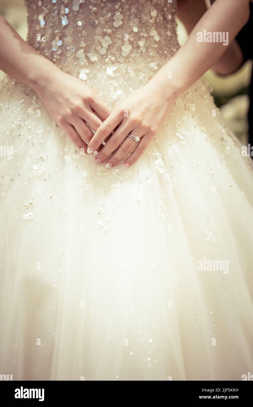Bride hand with a wedding ring on the background of dress, Detail image ...