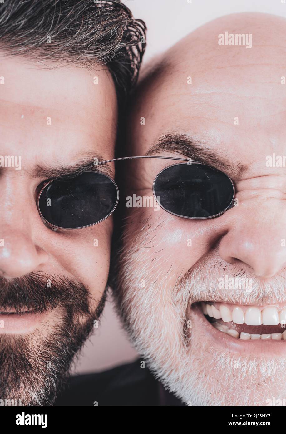 Close-up portrait of men. Glasses for two. Bearded father and son ...
