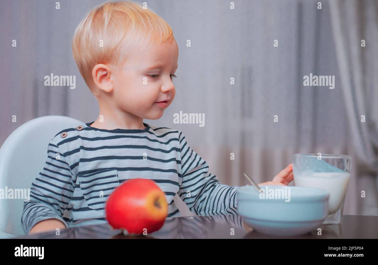 Baby nutrition. Eat healthy. Toddler having snack. Drink milk. Child ...
