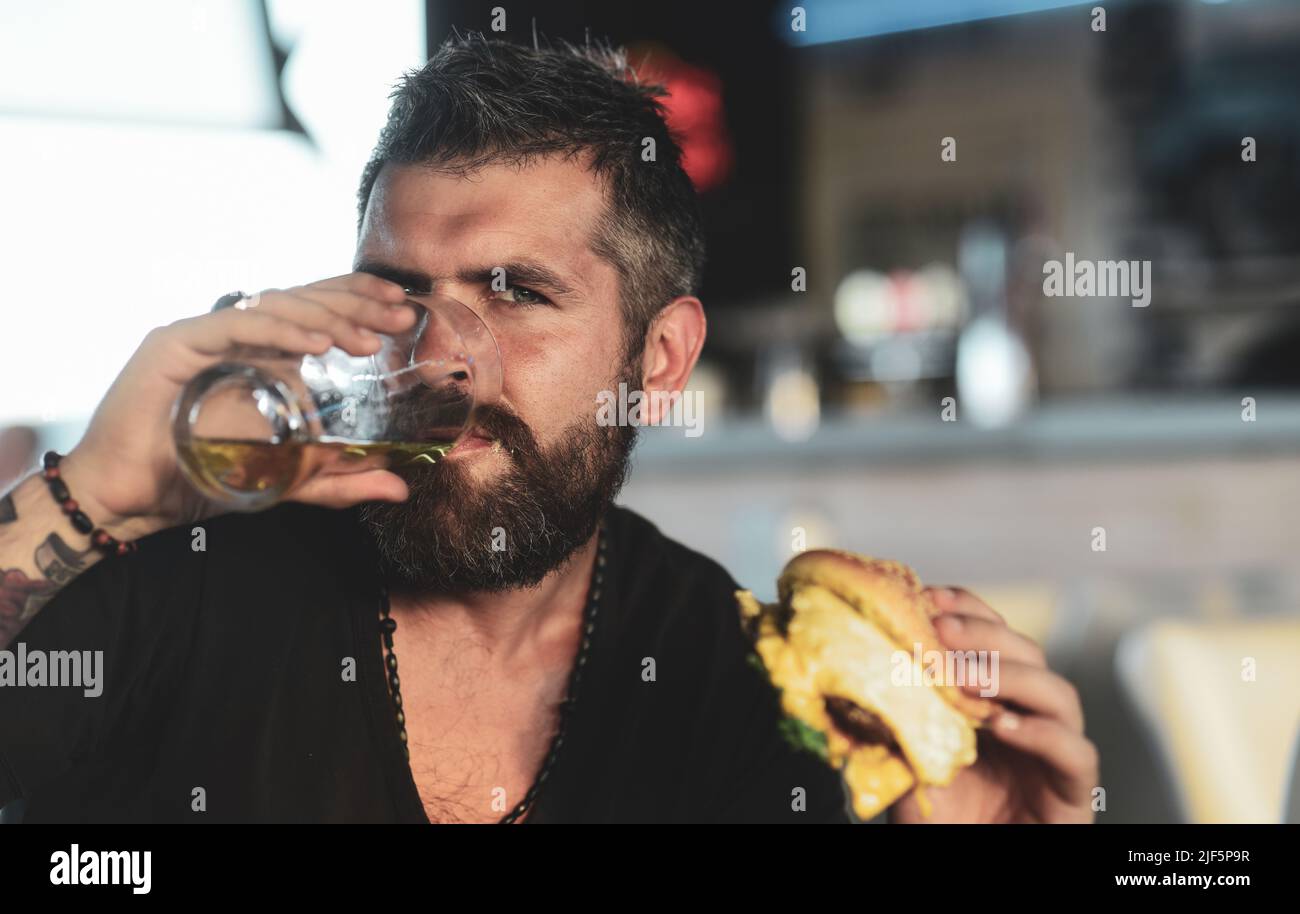 Beer pubs and bars. Hipster relaxing at pub. Beard man drinking beer ...