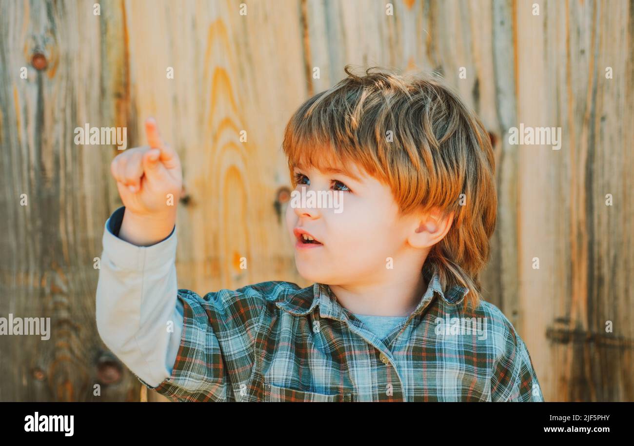 Cute kid pointing up. Learning and discovering. Happy childhood. Spring ...