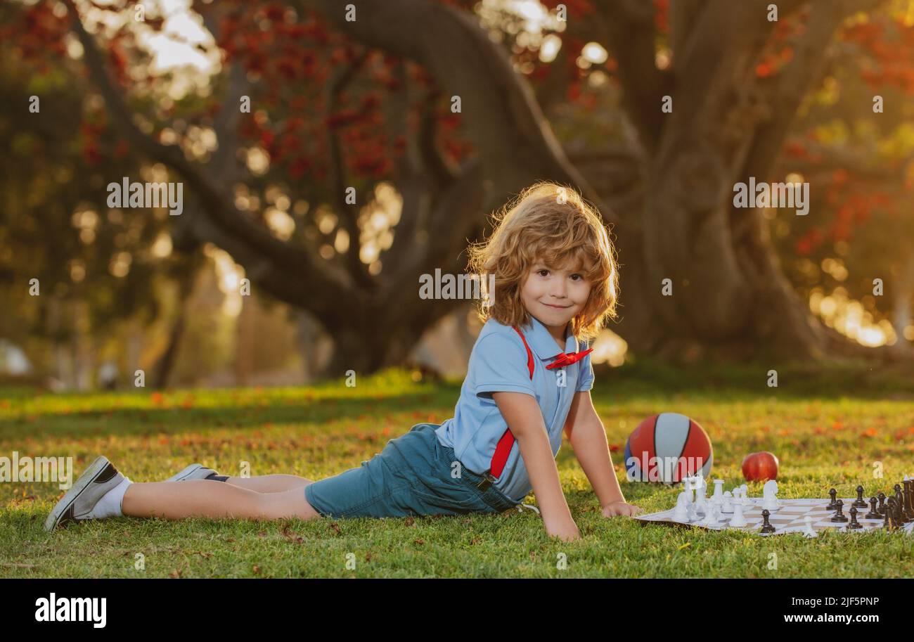 Kid playing chess in park. Child learning to play chess. Little boy ...