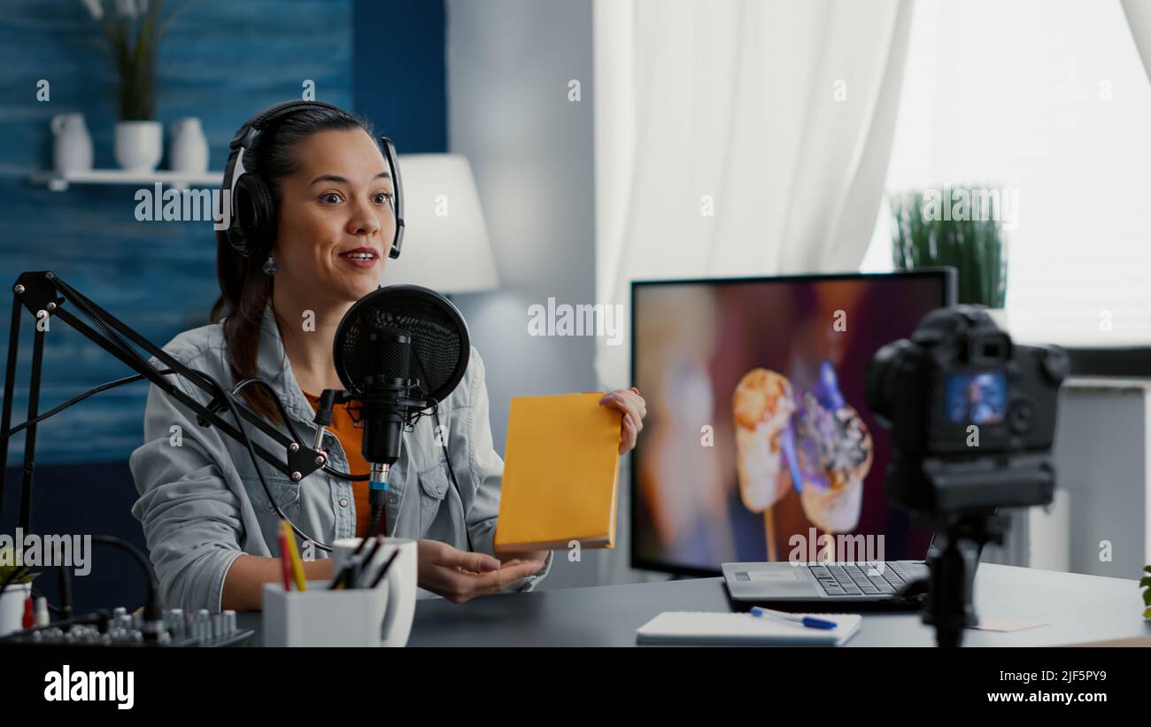 Social media influencer recording agenda review while in home studio ...