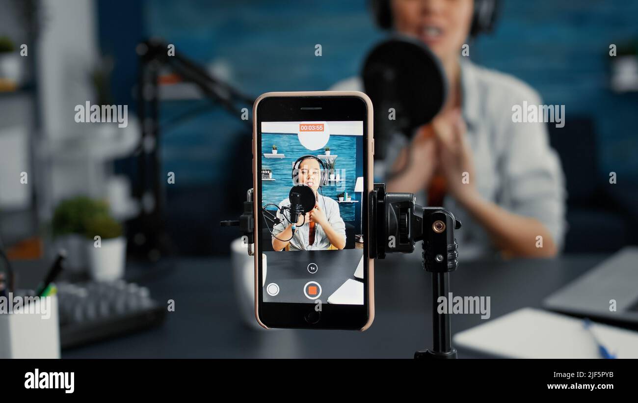 Modern smartphone recording vlogger talking to public while sitting at ...