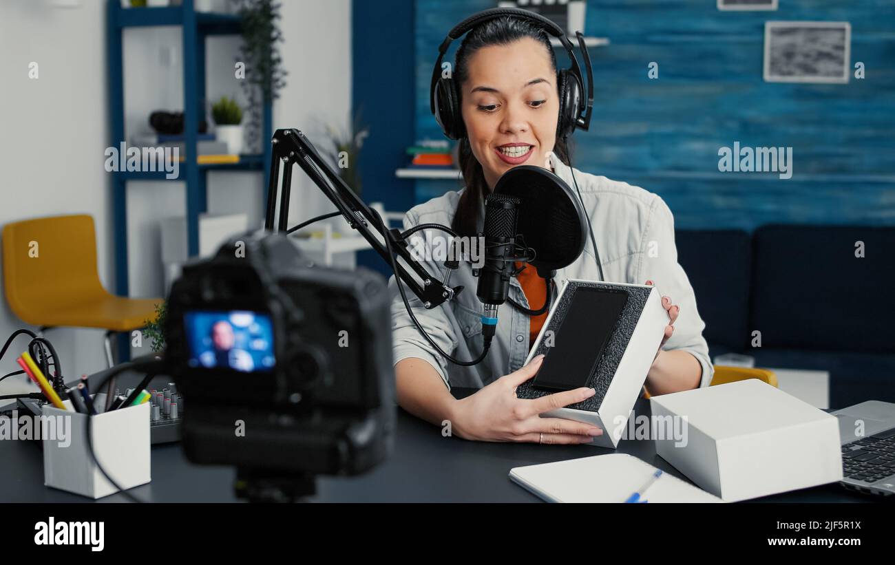 Tech vlogger doing unpacking review video of mobile phone while ...