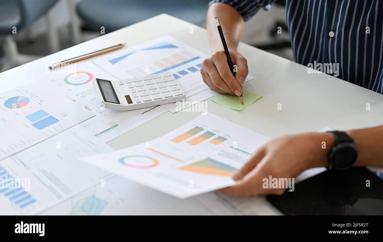 close-up image. Male accountant or financial consultant reviewing a ...