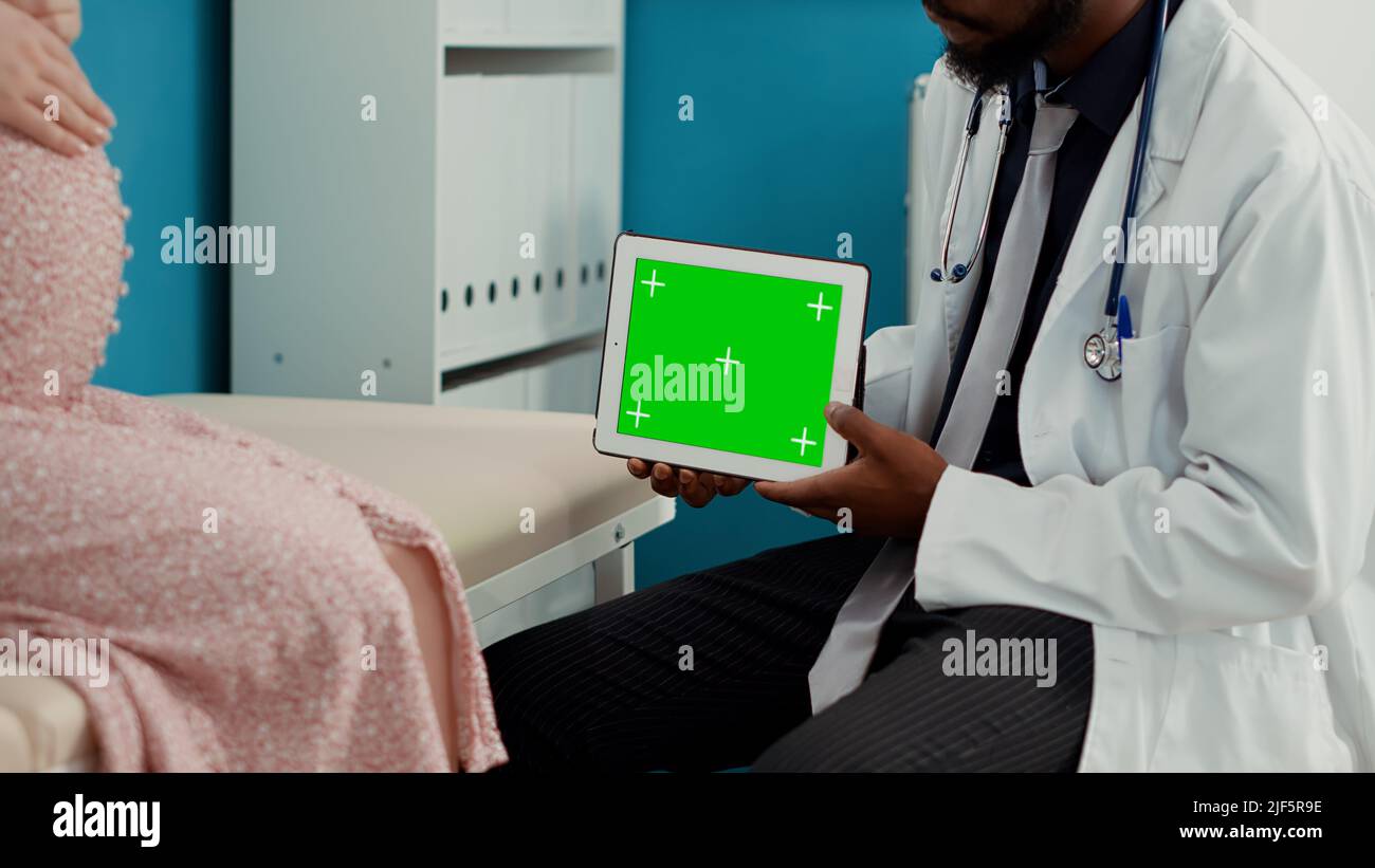 Pregnant woman specialist looking greenscreen hi-res stock photography ...