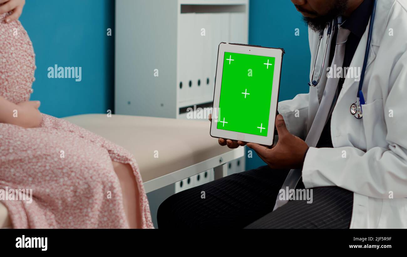 Male medic working with greenscreen on tablet at examination ...