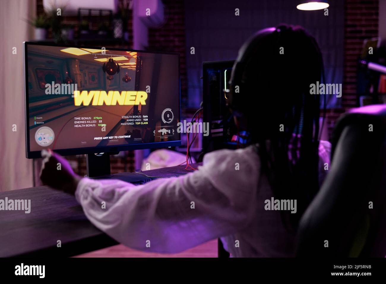 Content creator playing video games tournament on computer, celebrating ...